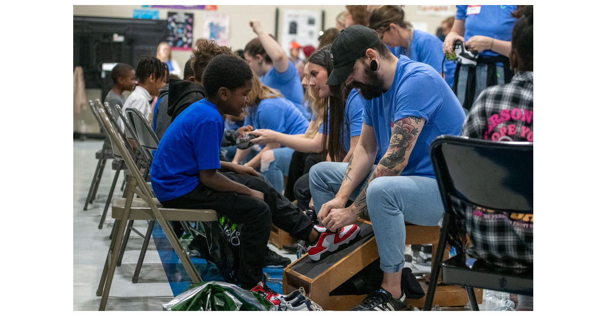 Photo of Genesco Employees Fitting Students with New Shoes at Ida B ...